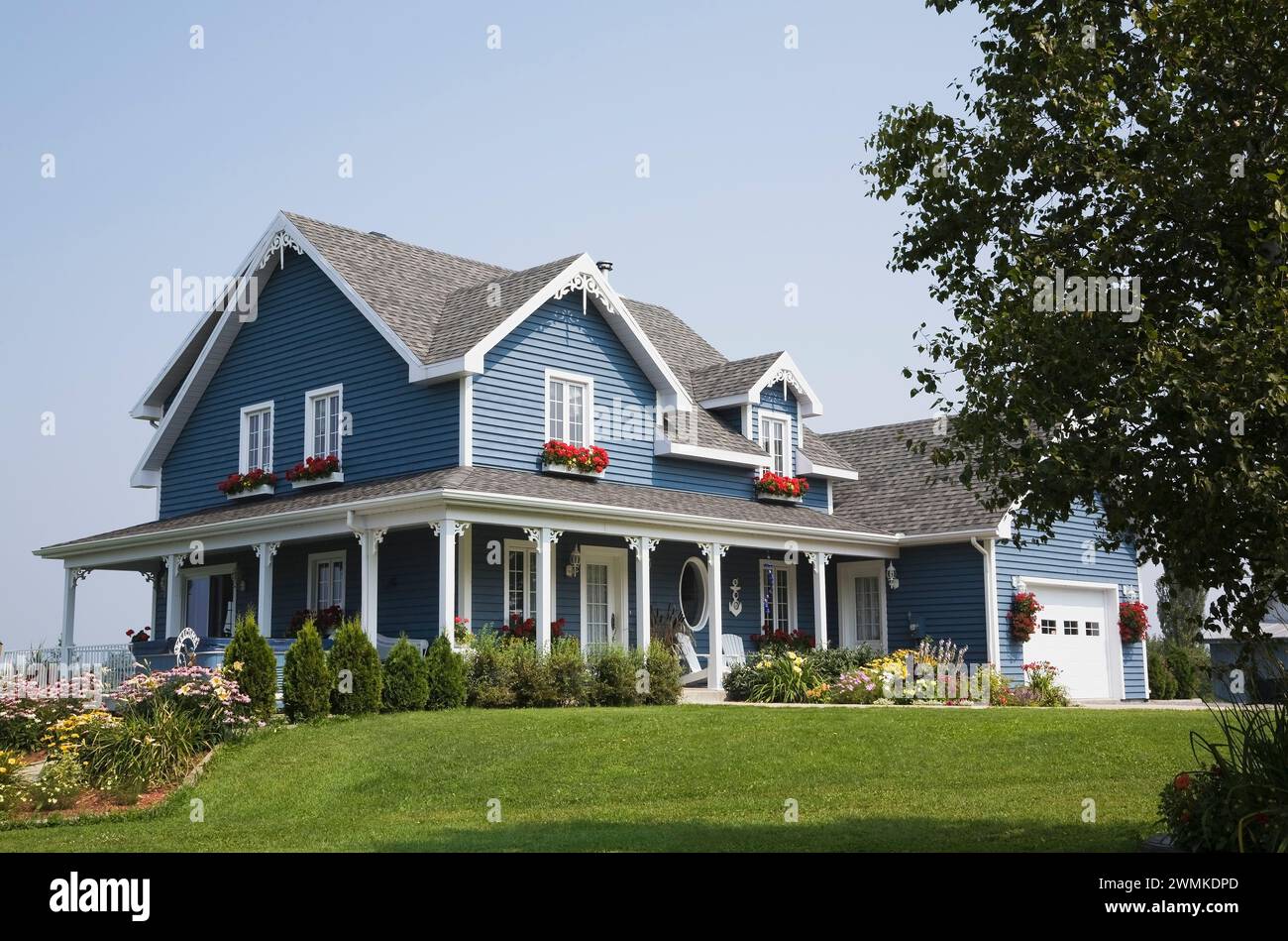 Blue wood plank clapboard with white trim two story home with long ...