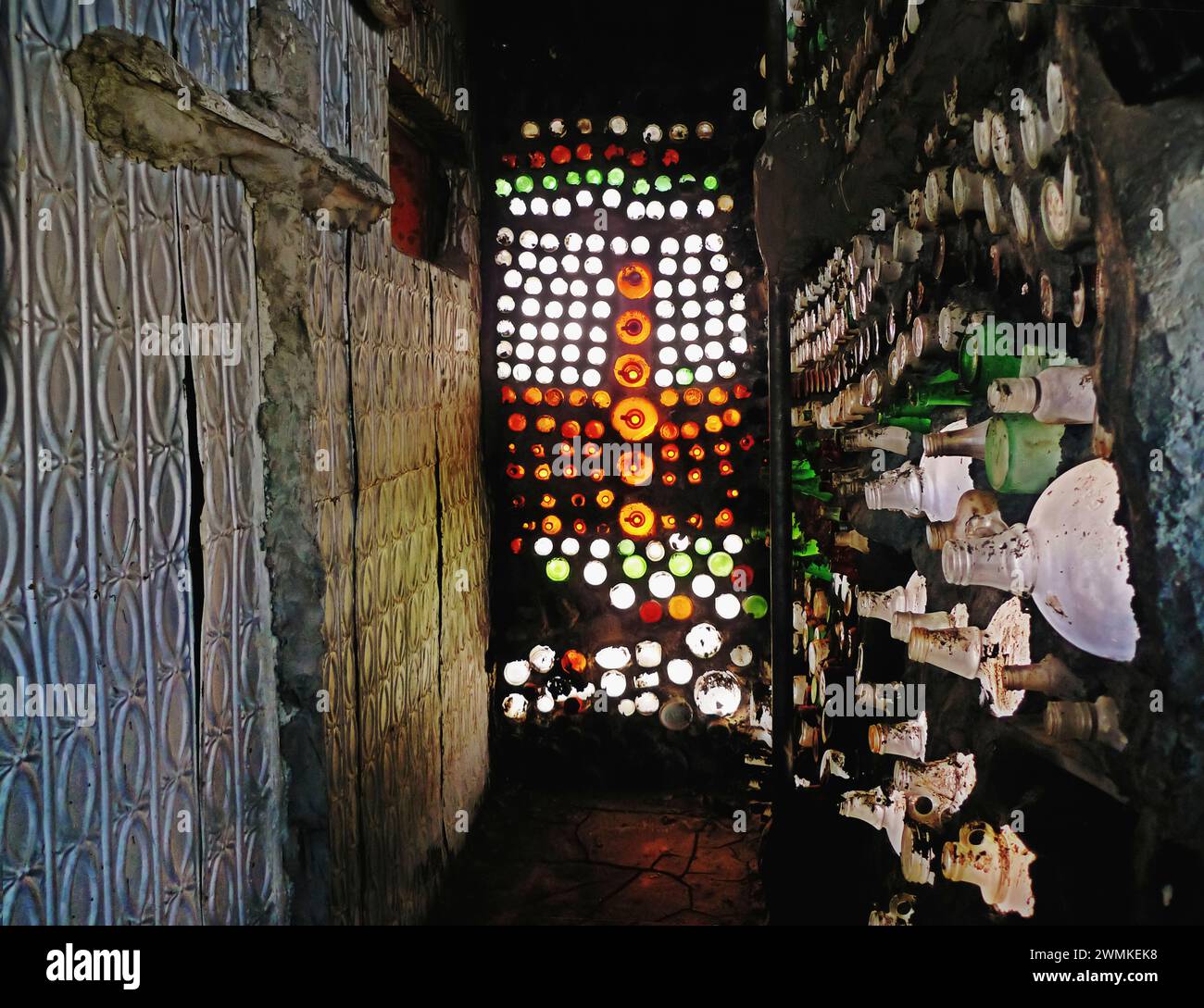 Colorful glass bottles, and embossed, metal ceiling tiles are ...
