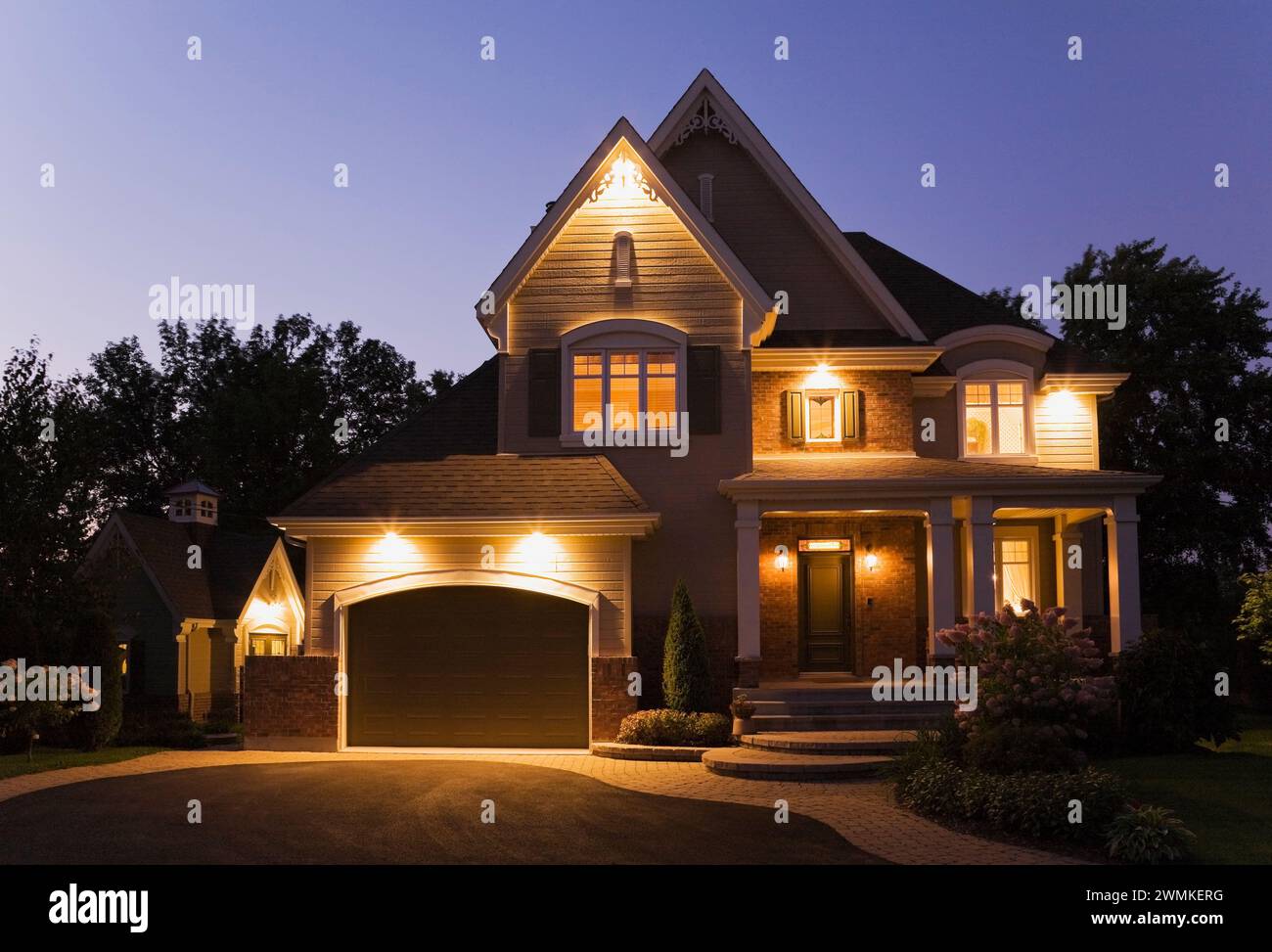 Two story red nuanced brick and tan clapboard cladded home with ...