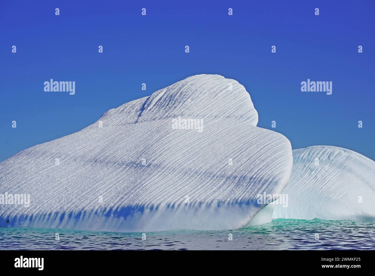 Melting iceberg under a bright blue sky Stock Photo - Alamy