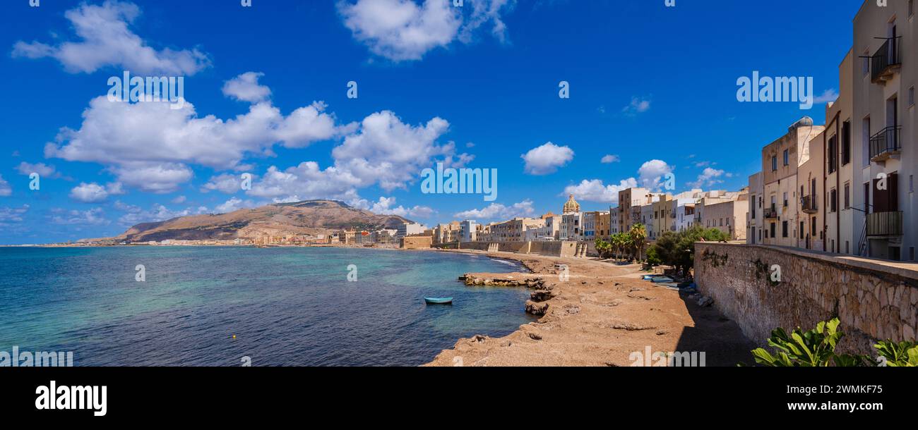 Trapani skyline with old, stone buildings and sea wall along the ...