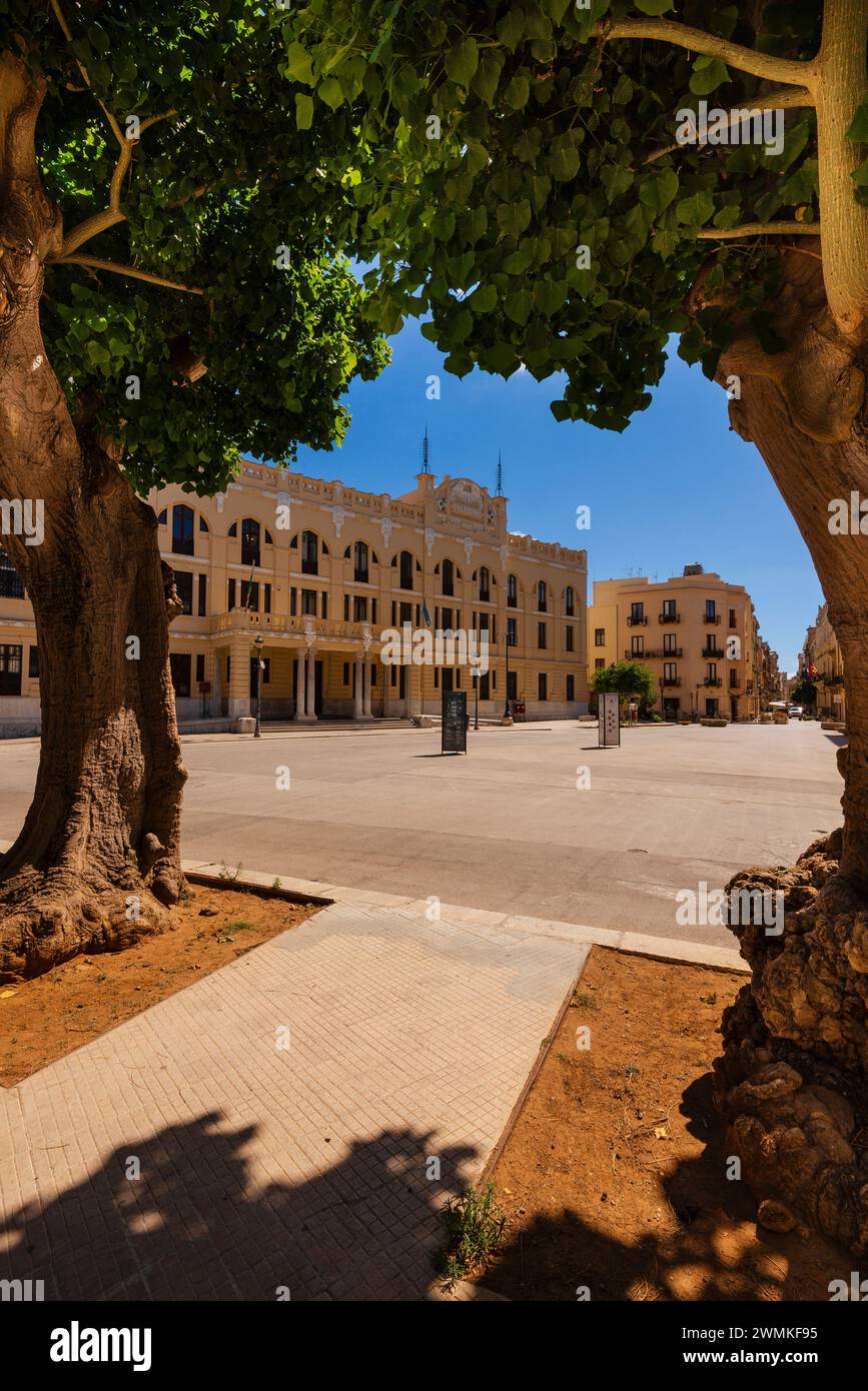 View through trees of the Post Office Building in Trapani City; Trapani ...