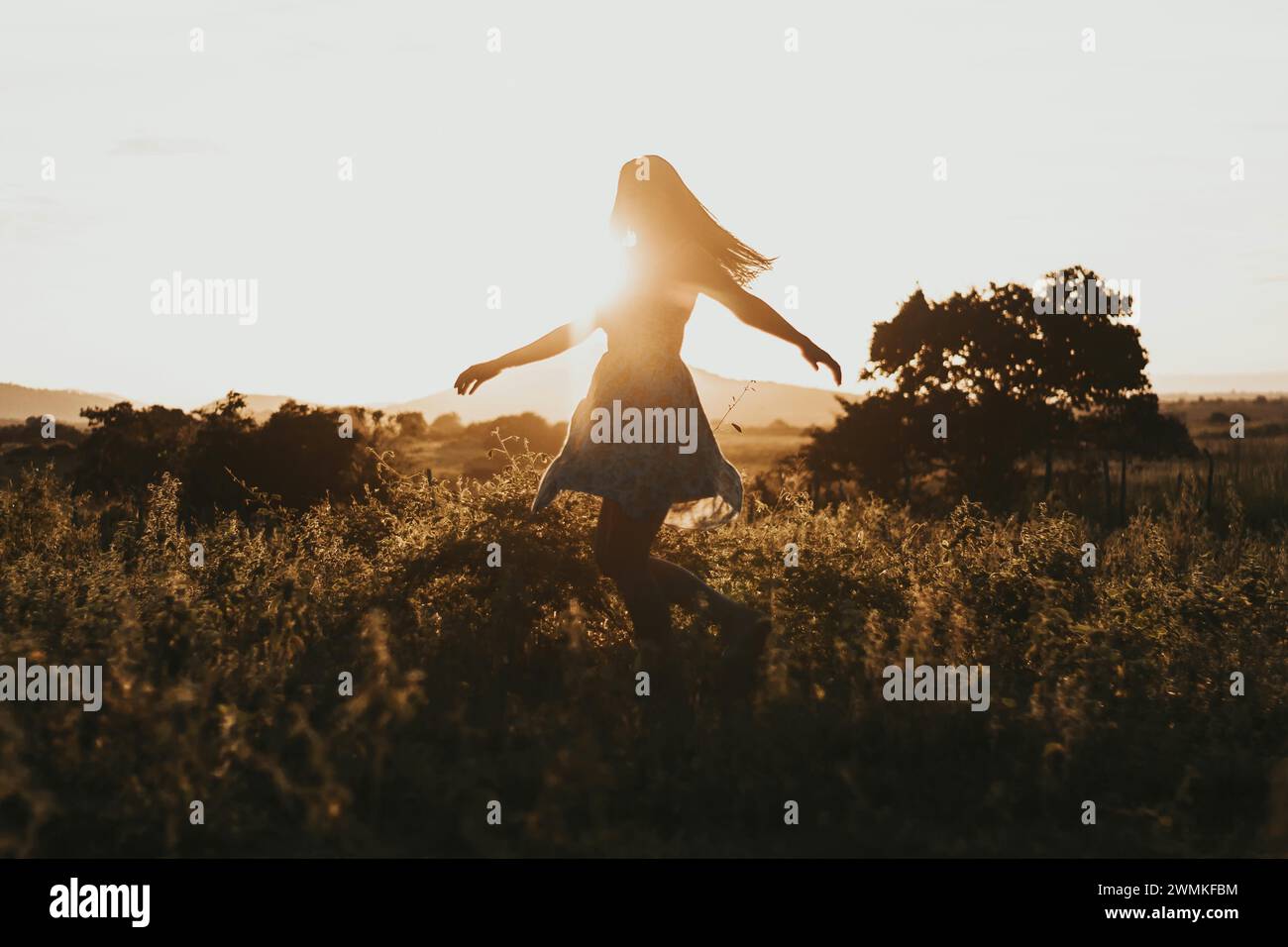Woman twirling at sunset hi-res stock photography and images - Alamy