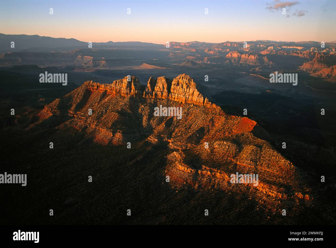 Cliffs and terraces and colorful layers of rock are illuminated on an ...