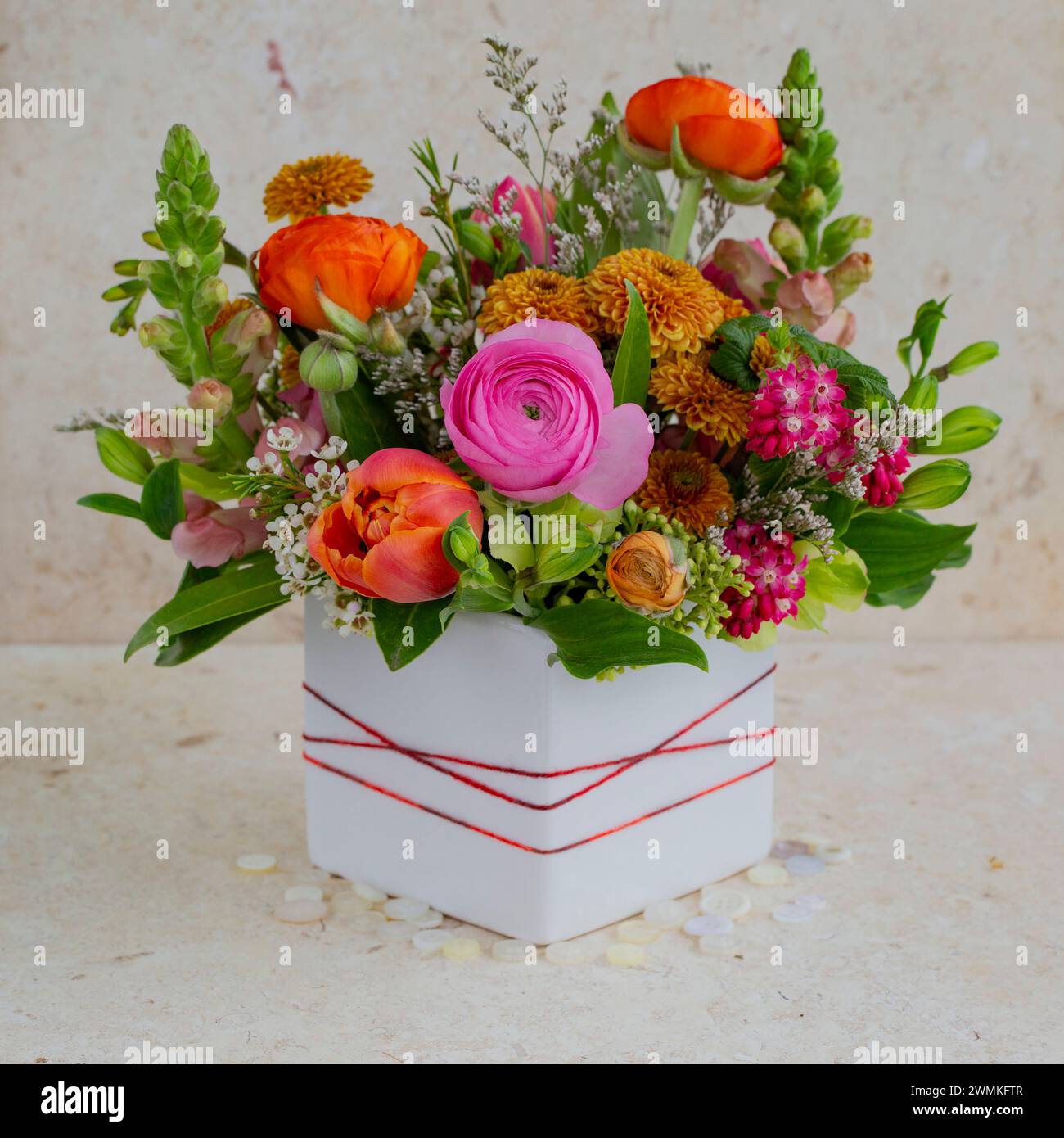 Colorful floral arrangement in square vase; Studio Shot Stock Photo - Alamy