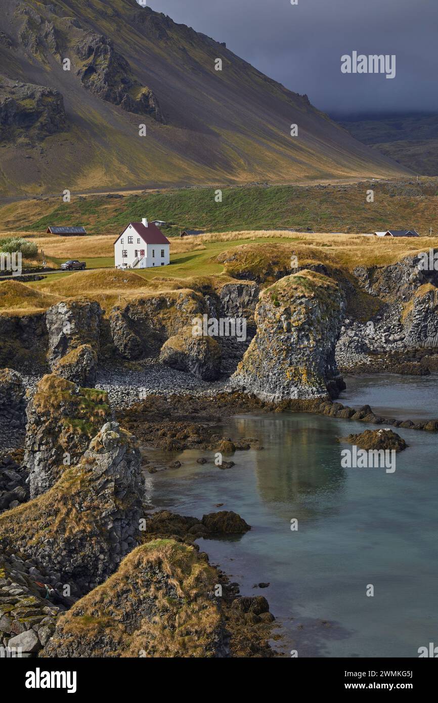 House and basaltic lava cliffs at Arnastapi, Snaefellsnes, Iceland ...