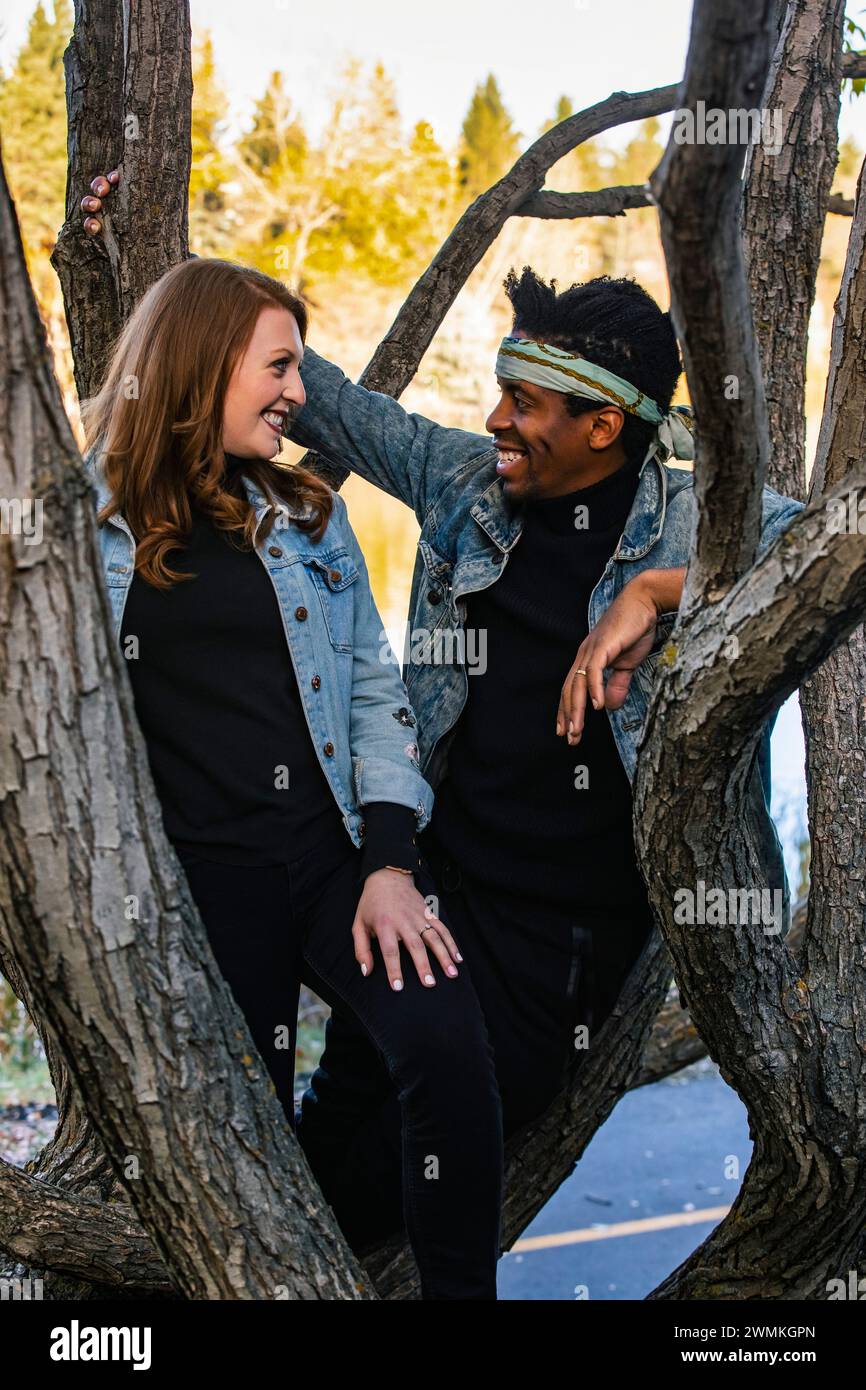 Close-up portrait of a mixed race couple smiling at each other while ...