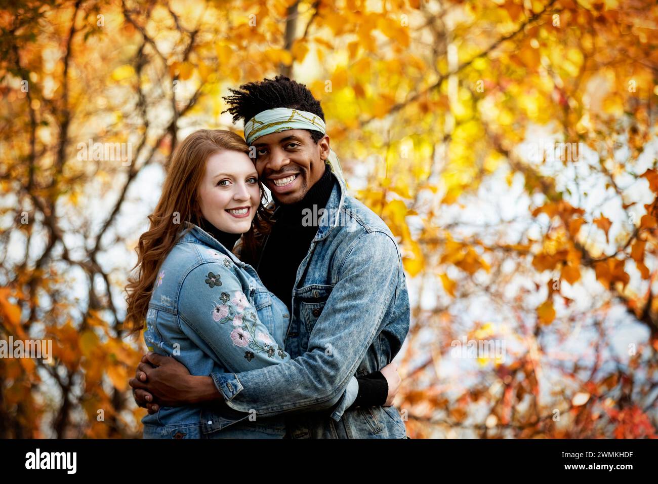 Close-up portrait of a mixed race married couple embracing and smiling ...