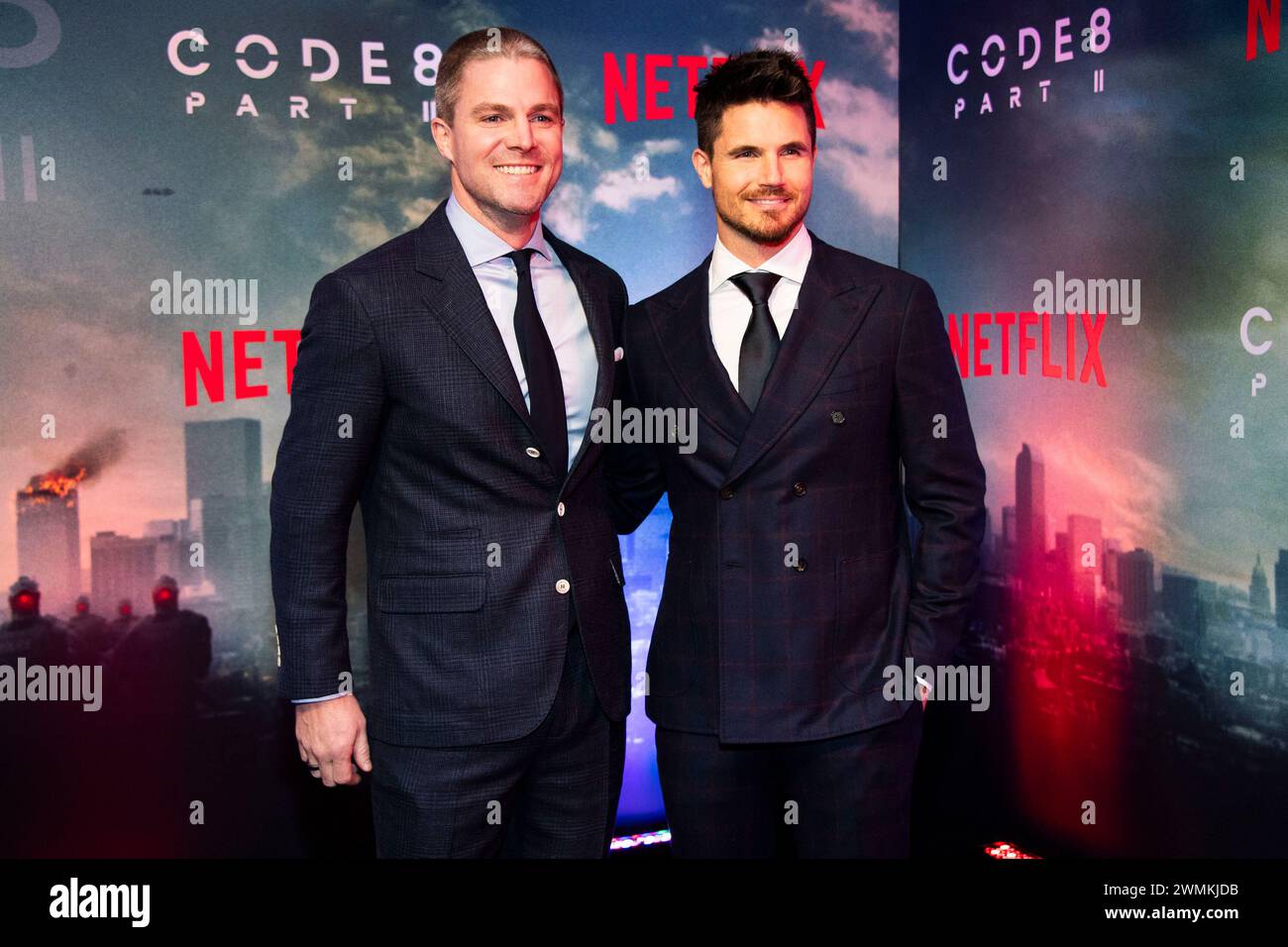 Stephen Amell, left, and Robbie Amell arrive at the premiere of "Code 8 ...