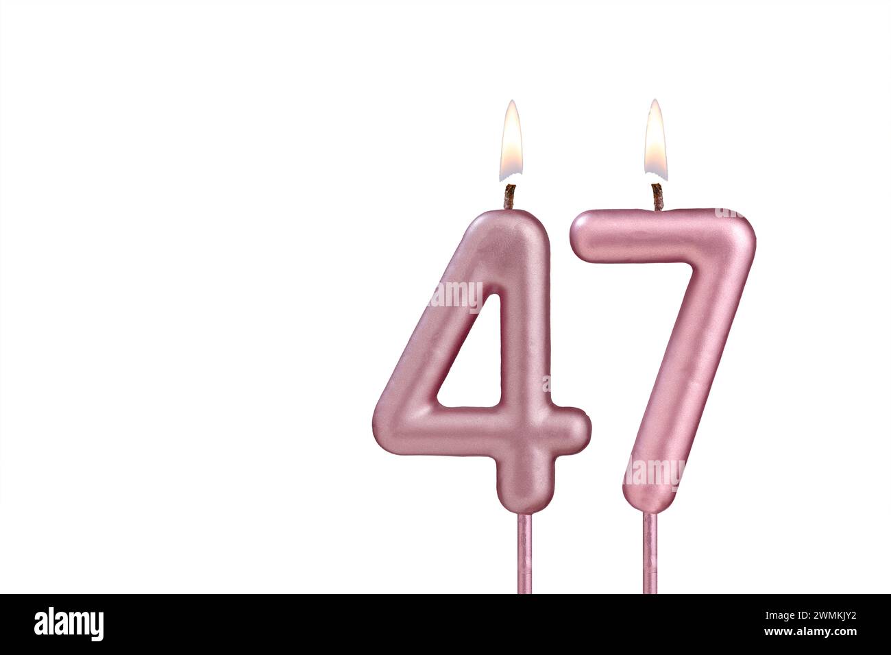 Candle number 47 - Lit birthday candle on white background Stock Photo ...