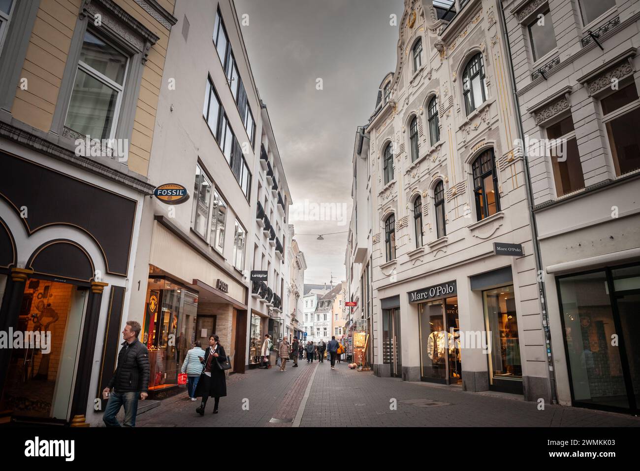Picture of facades of a medieval street at dusk, with shops and ...