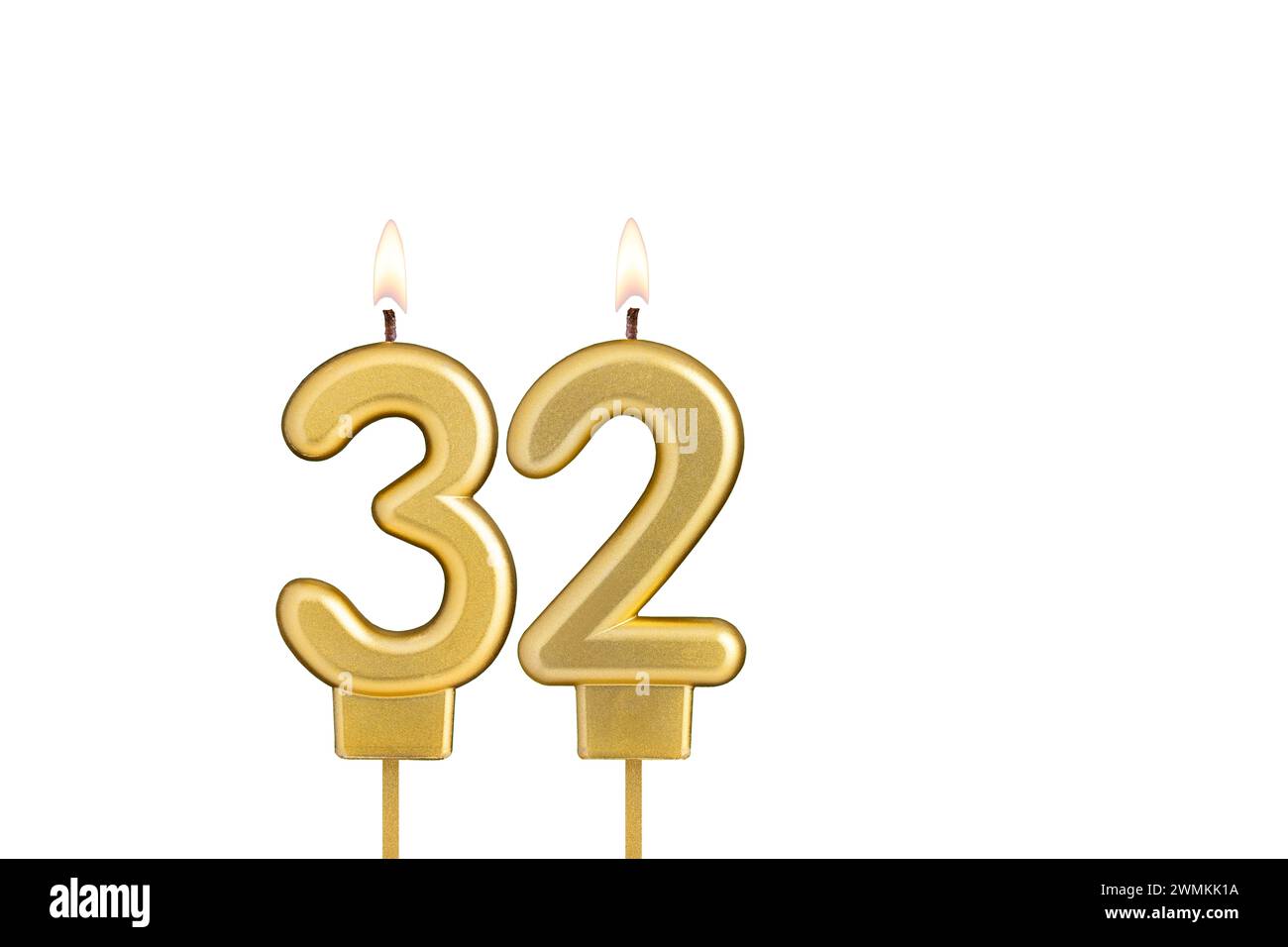 Golden number 32 birthday candle on white background Stock Photo - Alamy