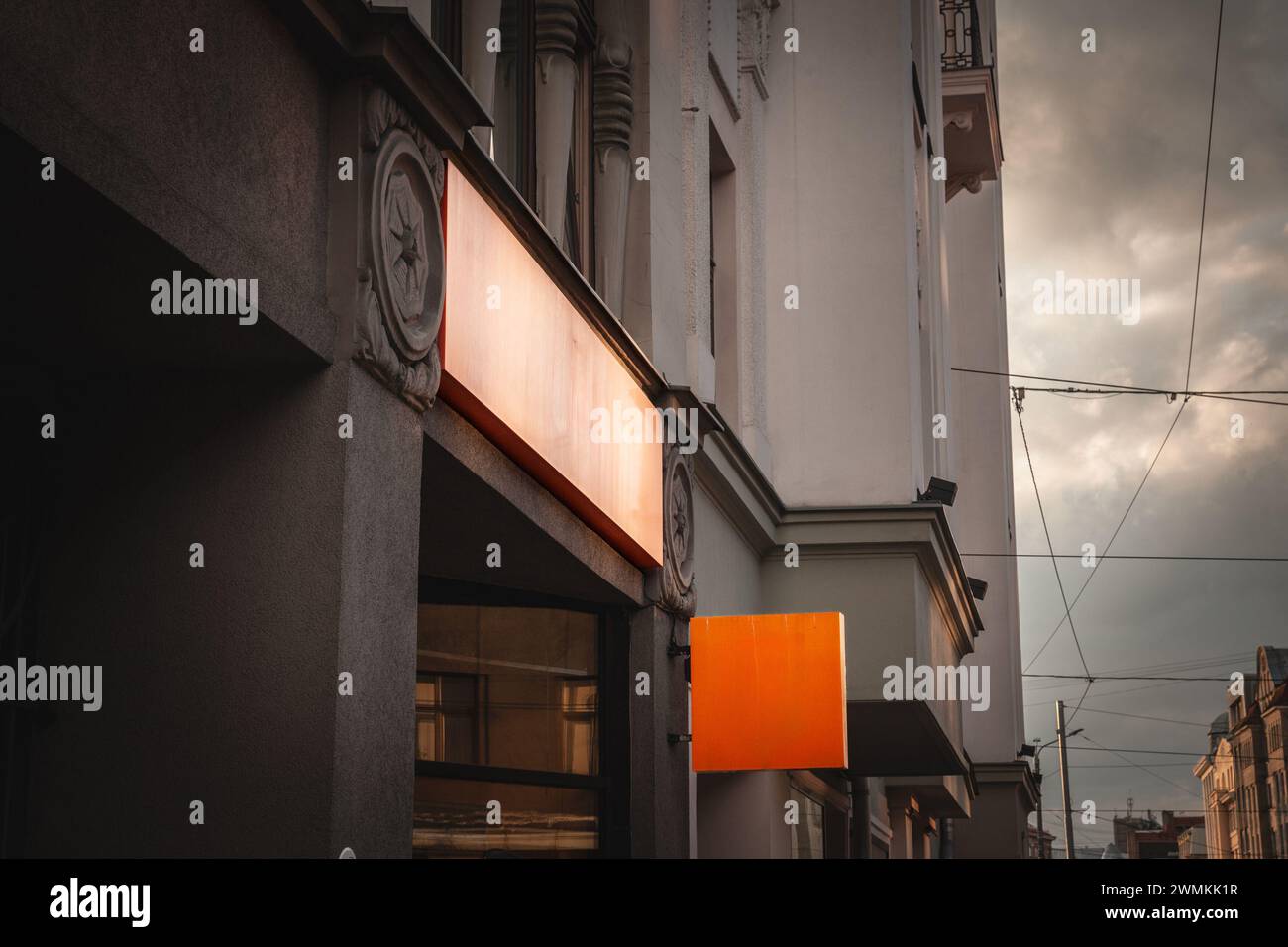 An empty, vibrant orange square signboard, prominently displayed and ...