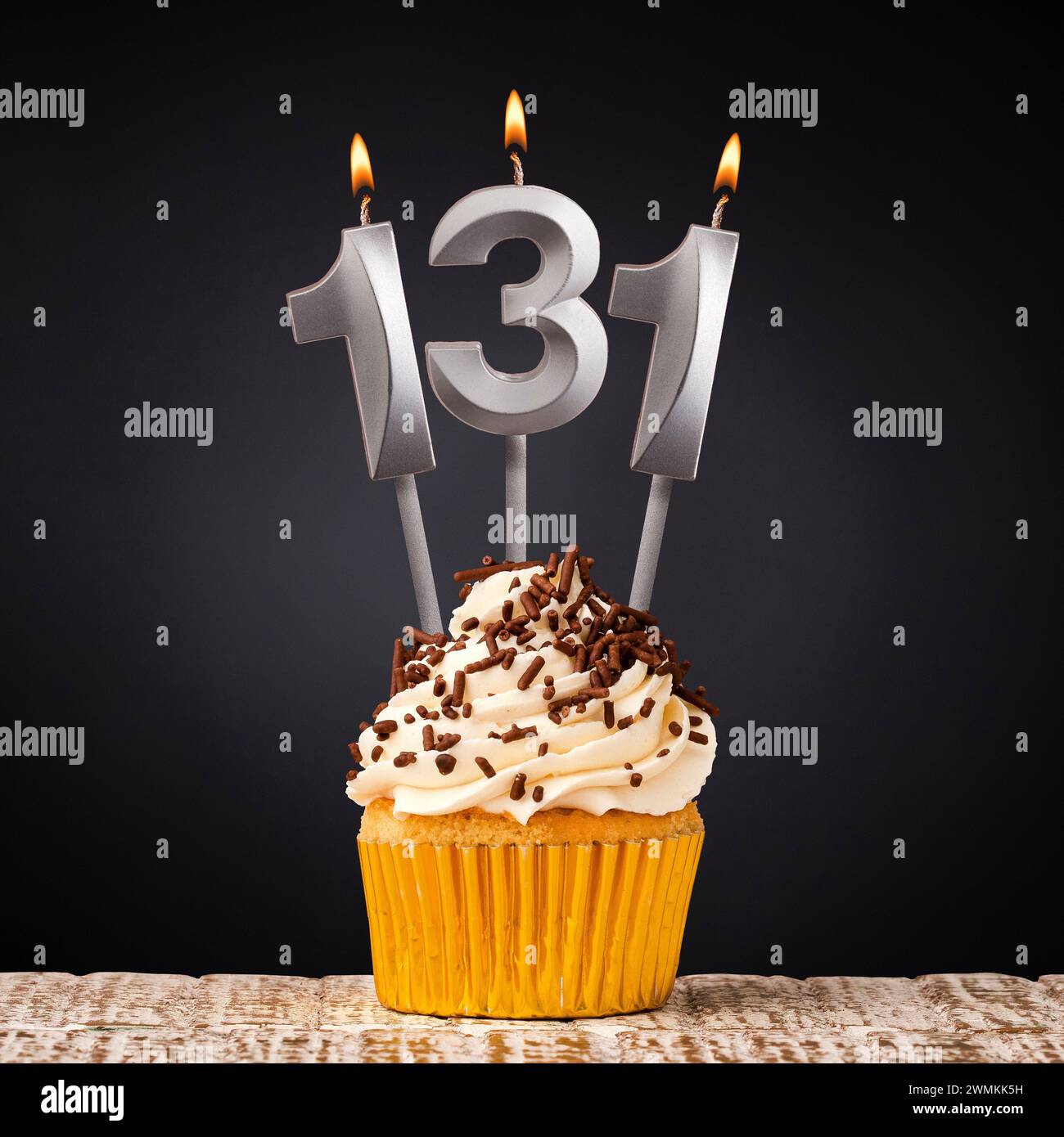 Birthday candle number 131 - Anniversary cupcake on black background ...