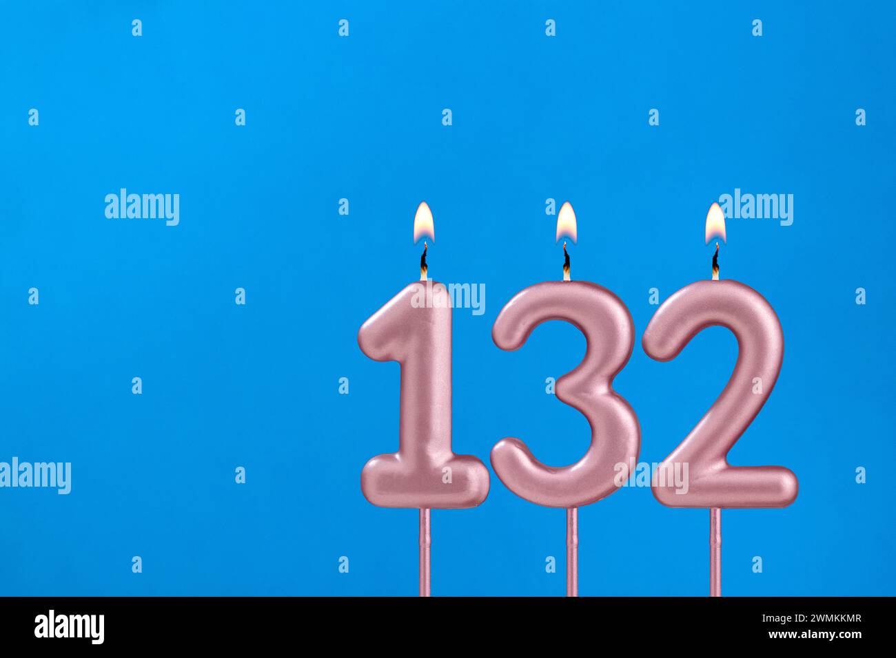 Number 132 - Burning anniversary candle on blue foamy background Stock ...