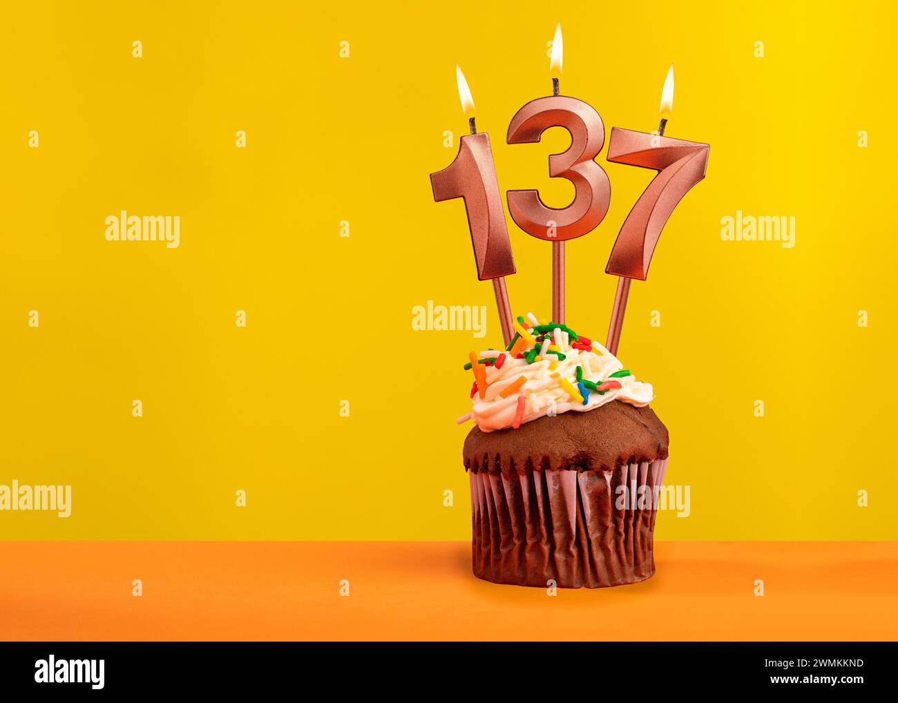 Candle with flame number 137 - Birthday card on yellow background Stock ...