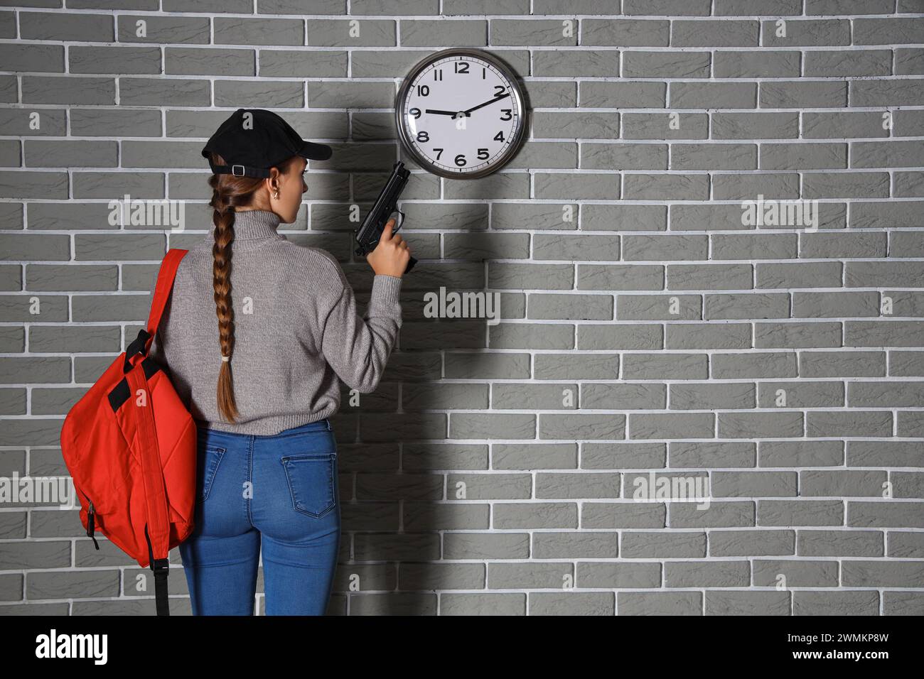 Female student with gun at school, back view Stock Photo - Alamy