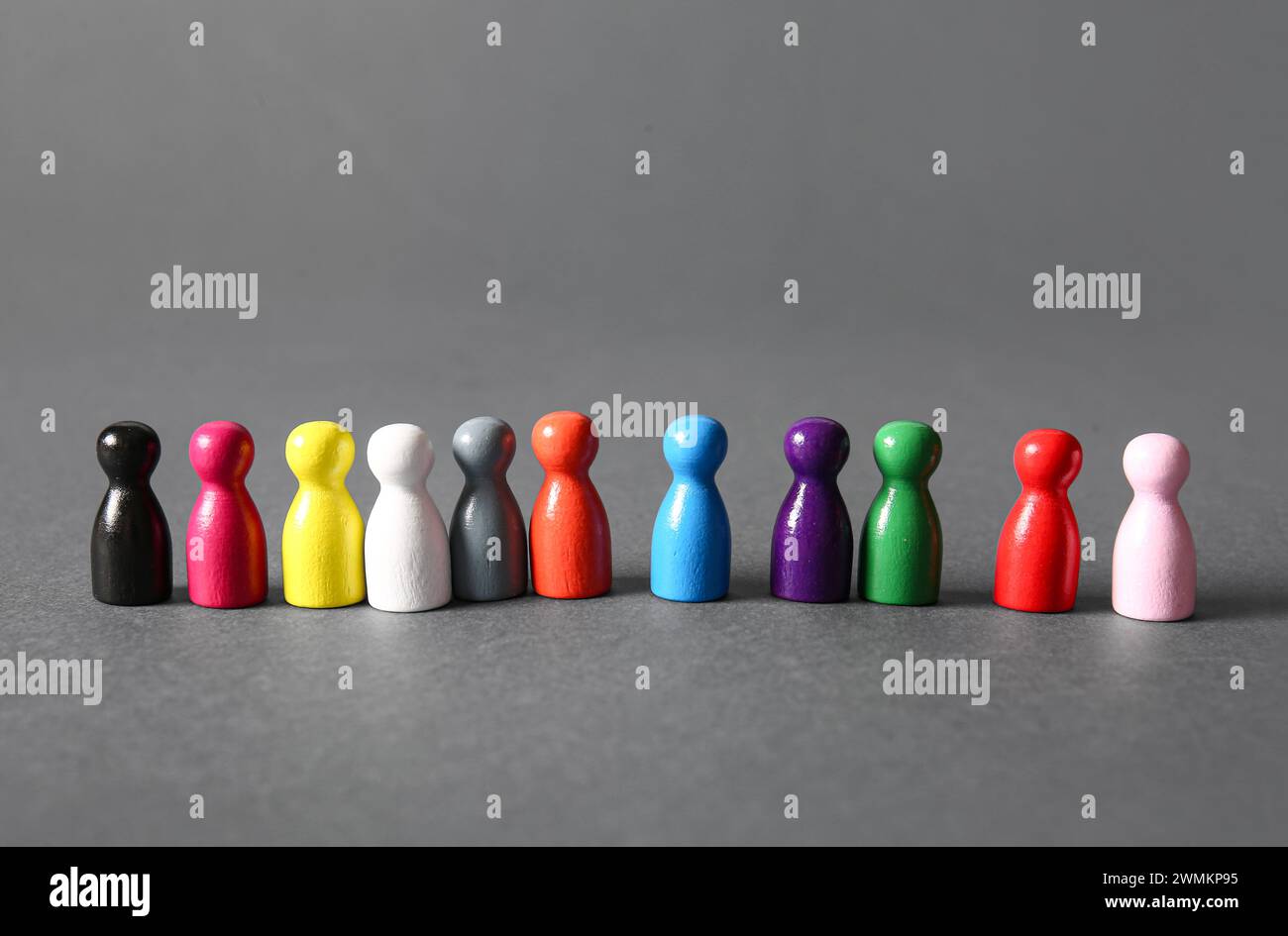 Row of colorful human figures on grey background. Inclusion concept ...