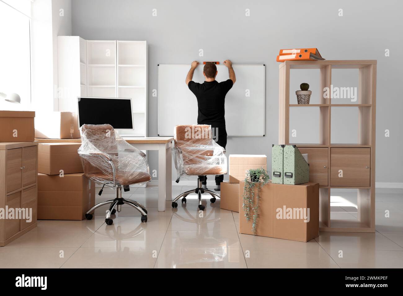 Interior of office with chairs wrapped in stretch film and cardboard ...