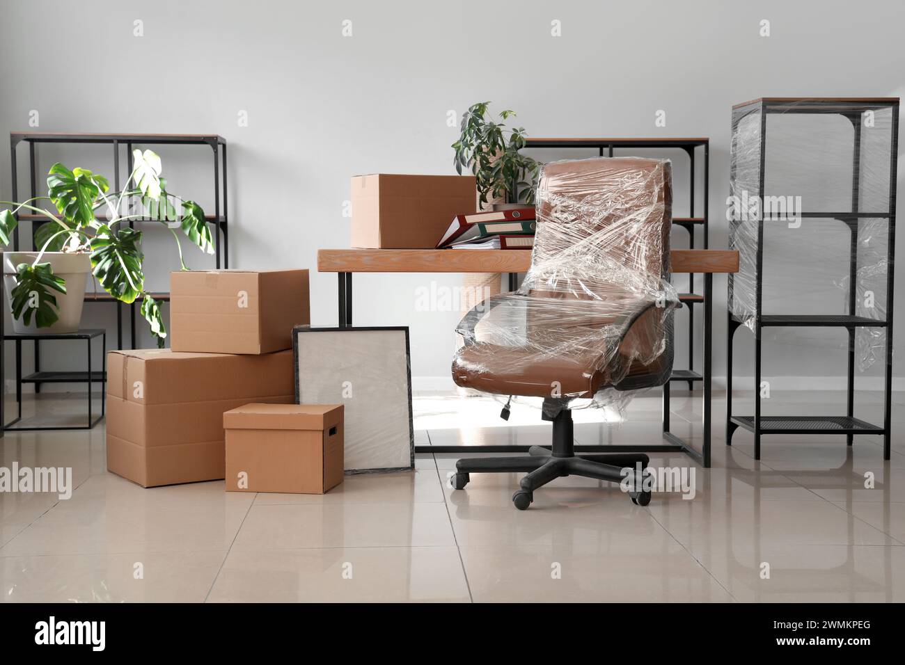Interior of office with chair wrapped in stretch film and cardboard ...