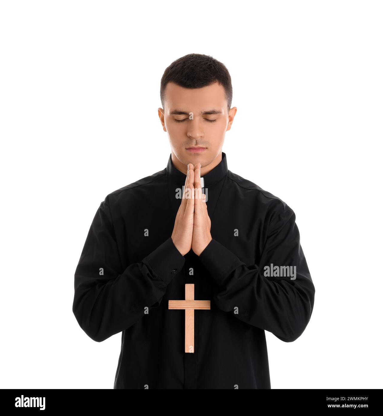 Young priest with cross paying on white background Stock Photo - Alamy