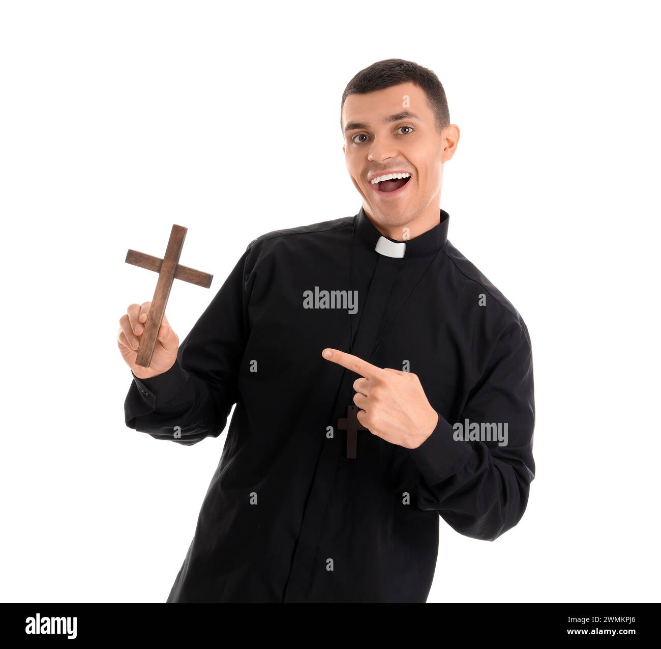 Young priest pointing at cross on white background Stock Photo - Alamy