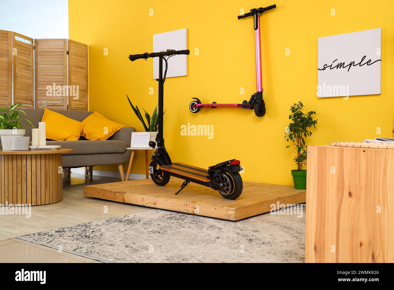 Interior of stylish living room with electric scooters, posters and ...