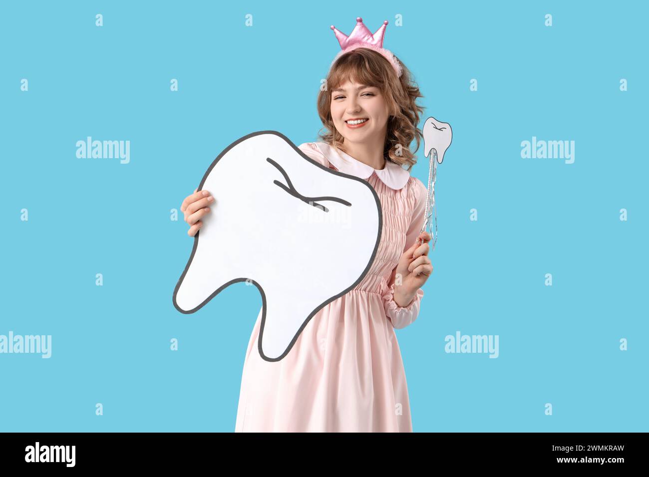 Tooth Fairy with paper figure and wand on blue background Stock Photo ...