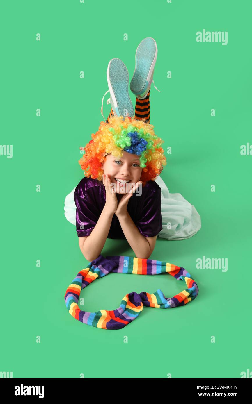Funny girl in clown costume with colorful tights in shape of heart ...