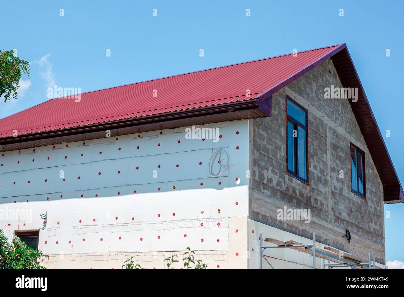 Built house with exterior work. Insulation of the external walls of the ...