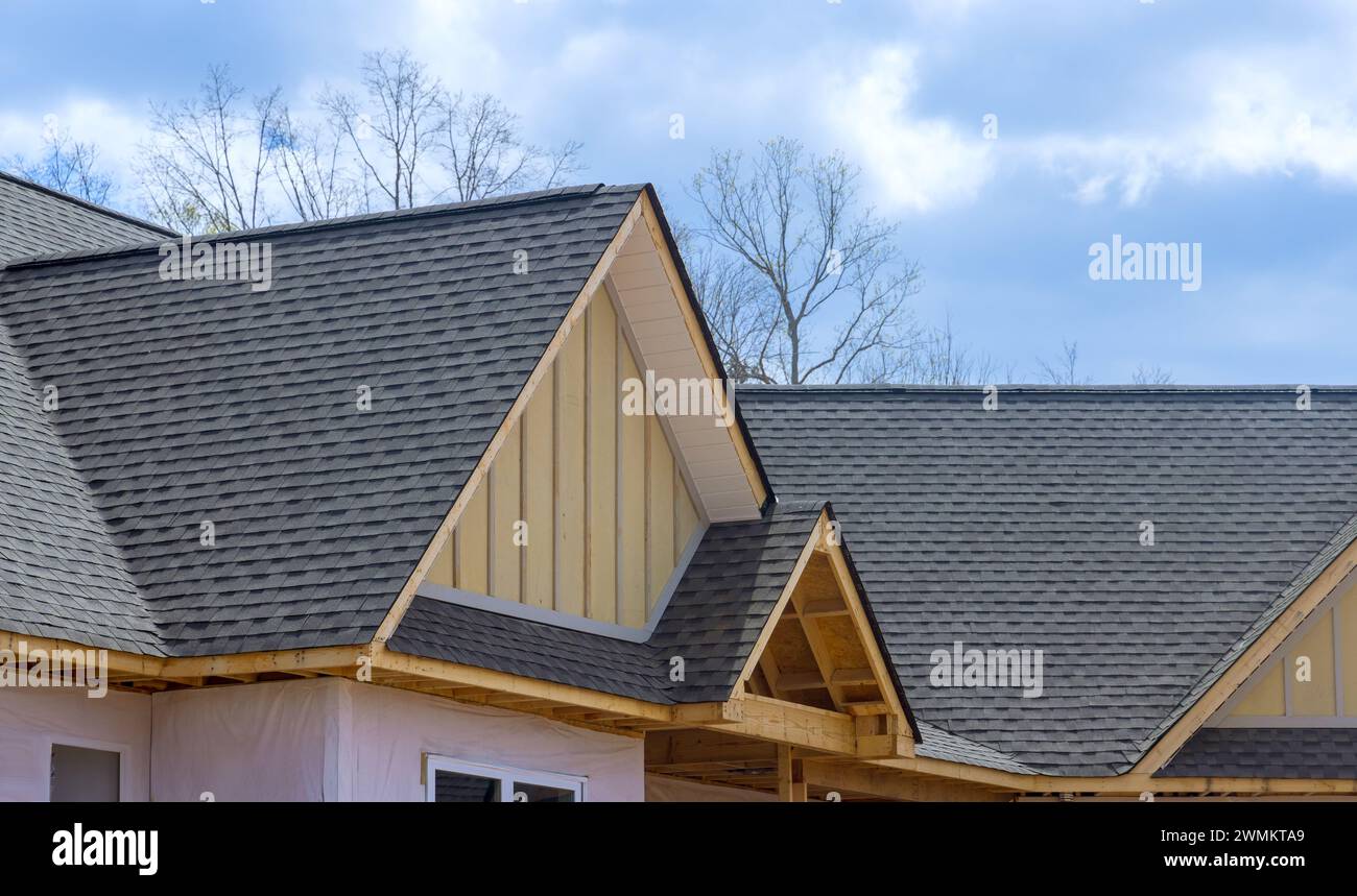 On newly constructed home, overlapping asphalt shingles are seen on ...