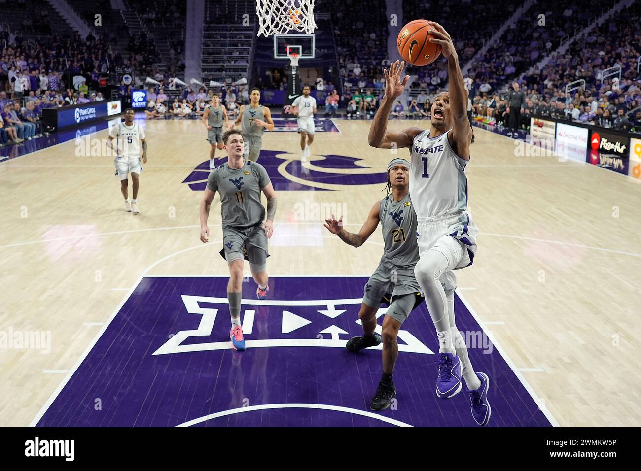 Kansas State forward David N'Guessan (1) gets past West Virginia guard ...
