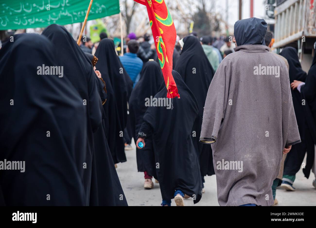 Budgam, India. 26th Feb, 2024. Kashmiri Shia Muslims walk while ...