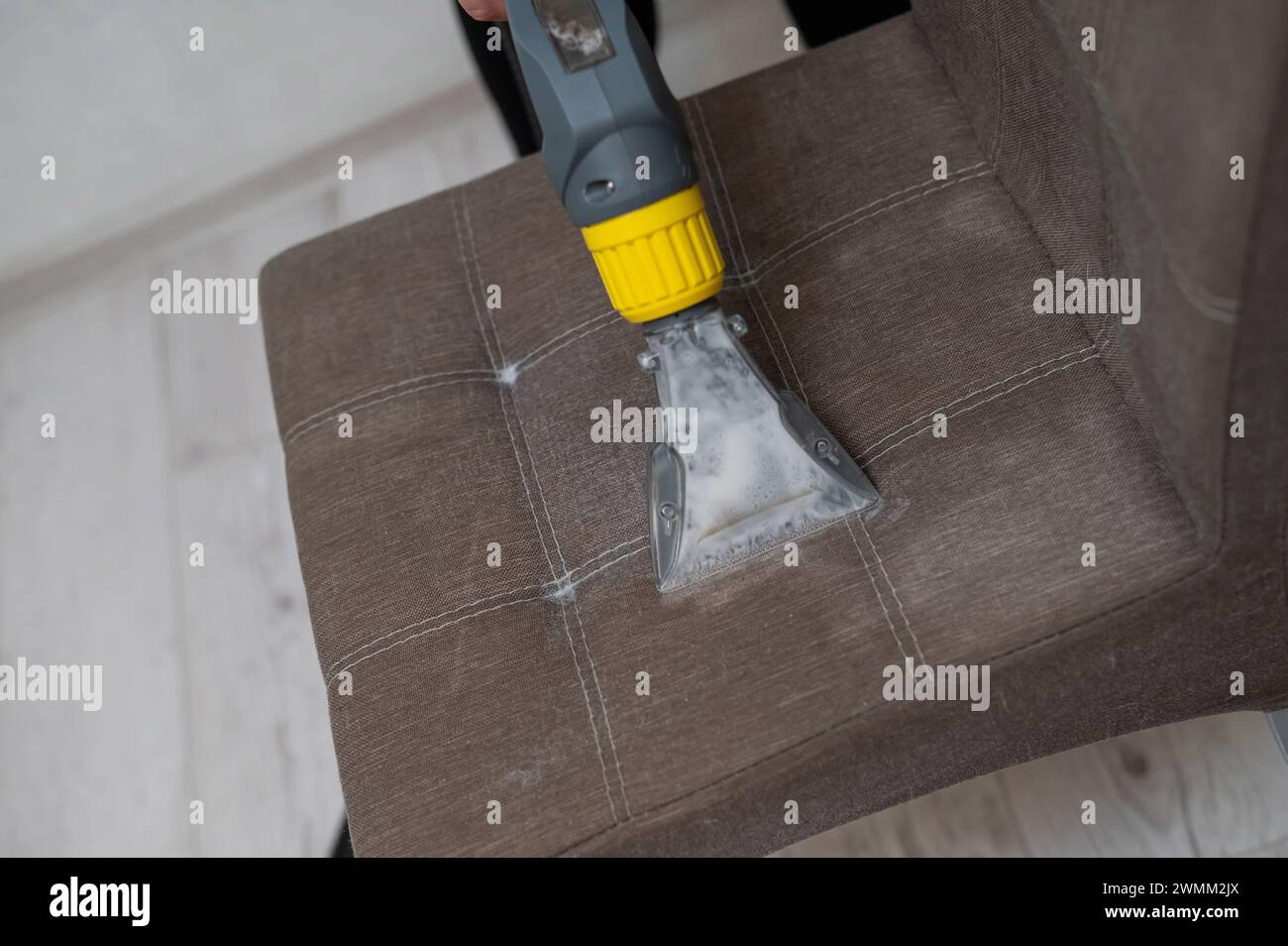 Dry cleaning a fabric chair Stock Photo - Alamy