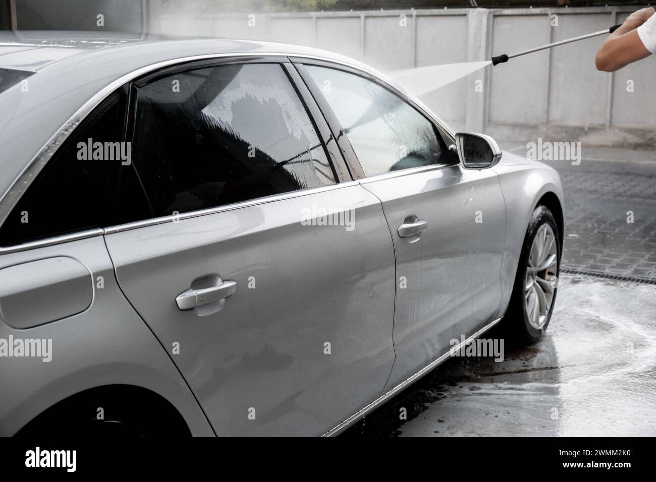 Washing luxury silver car on touchless car wash. Washing sedan car with ...