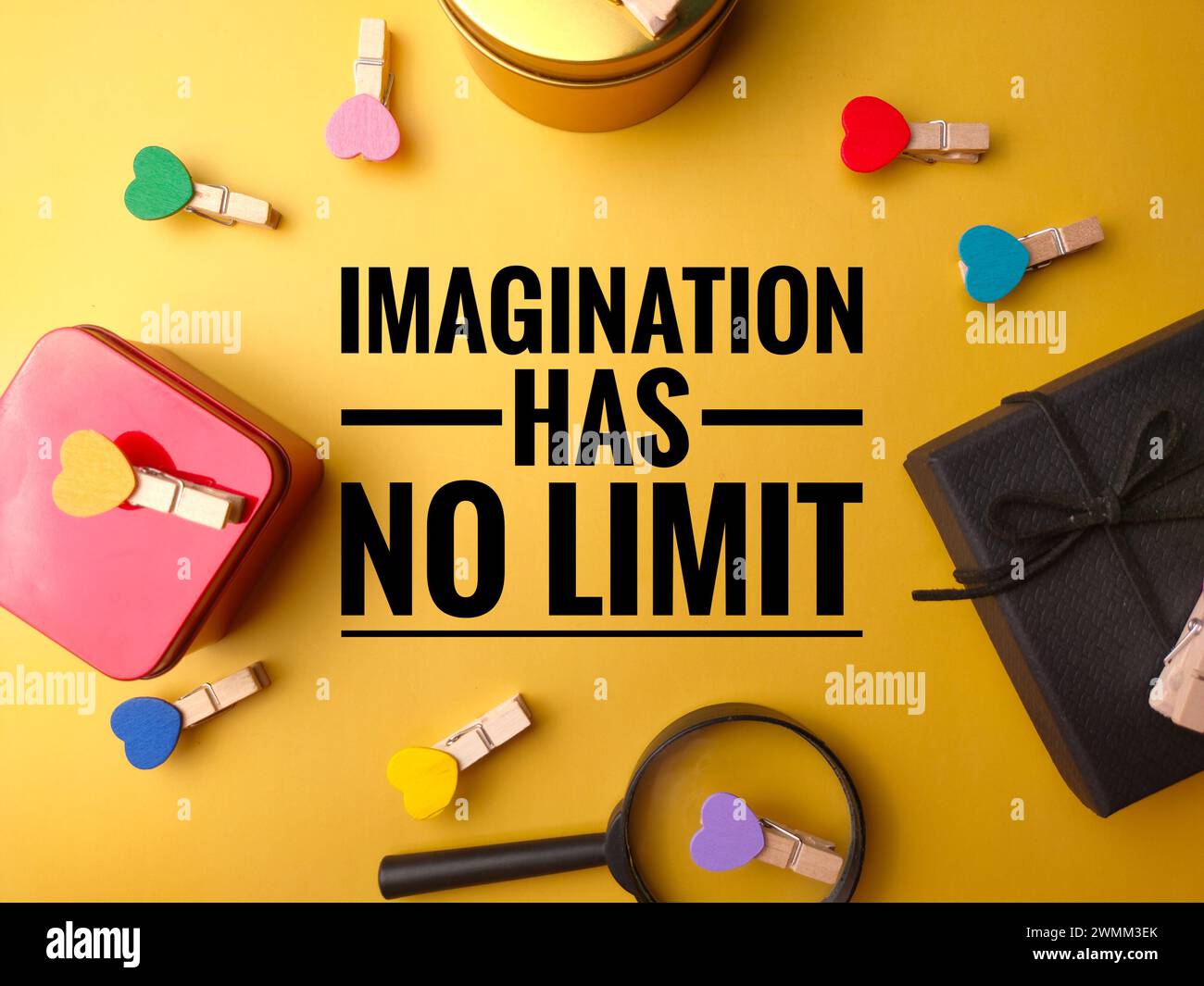 Top view colored box and colored wooden clips with text IMAGINATION HAS ...