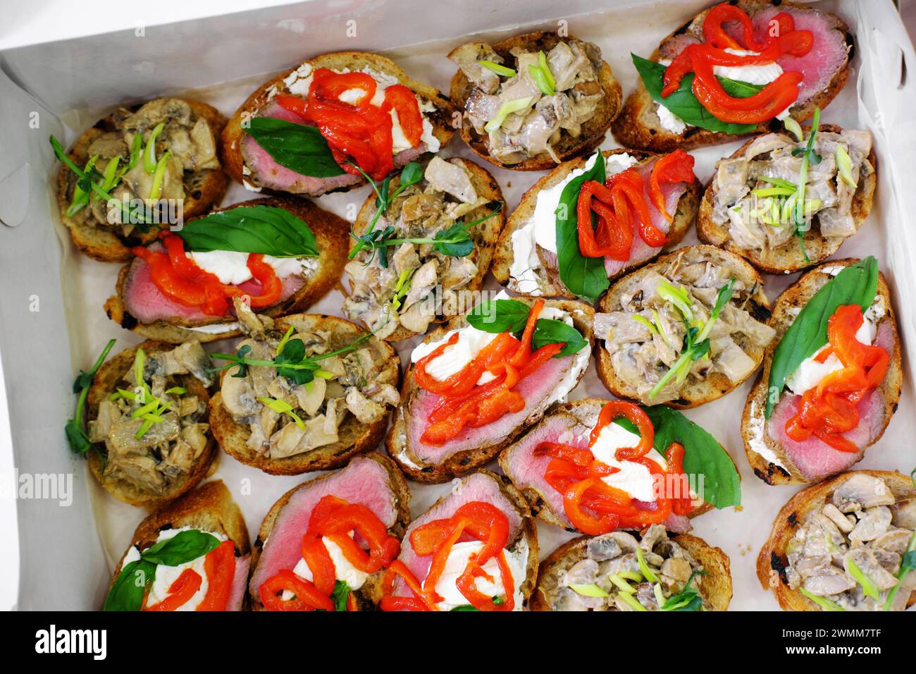 A colorful assortment of canapes with roast beef, fresh bell pepper ...