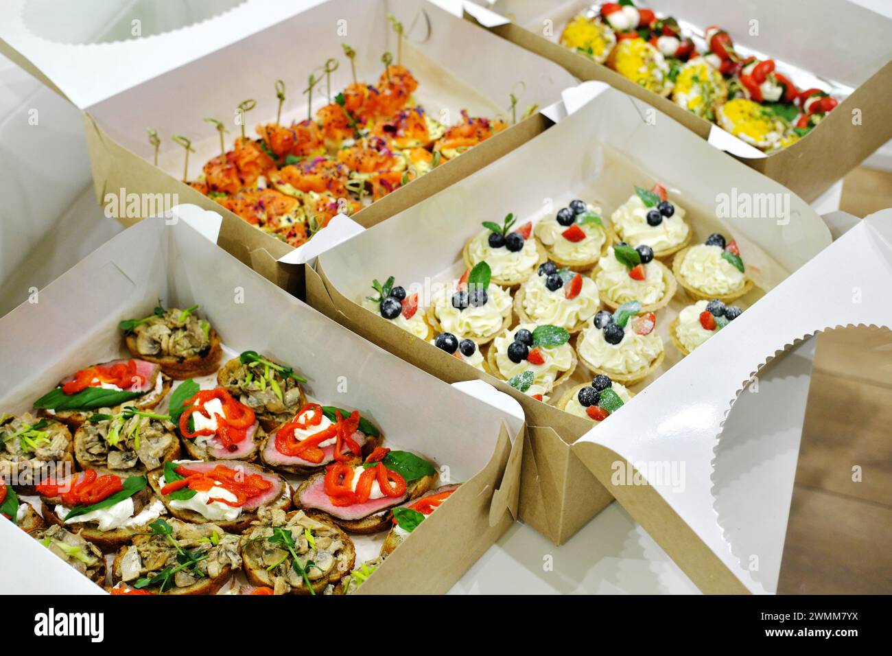 Cardboard boxes filled with a variety of appetizers including ...