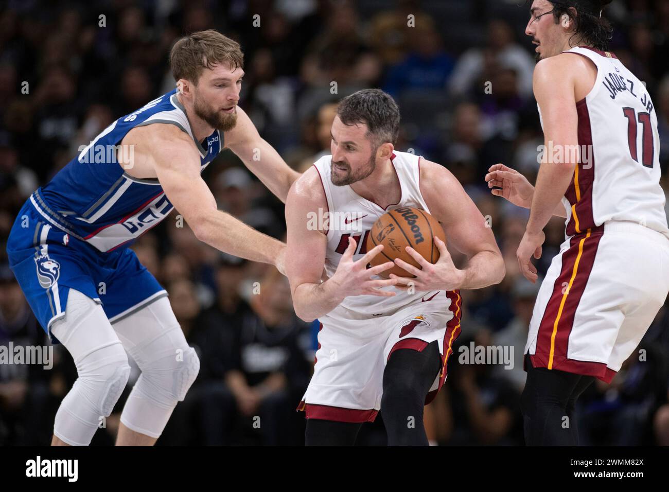 Miami Heat forward Kevin Love (42) picks up a loose ball between teammate Jaime Jaquez Jr. (11 ...