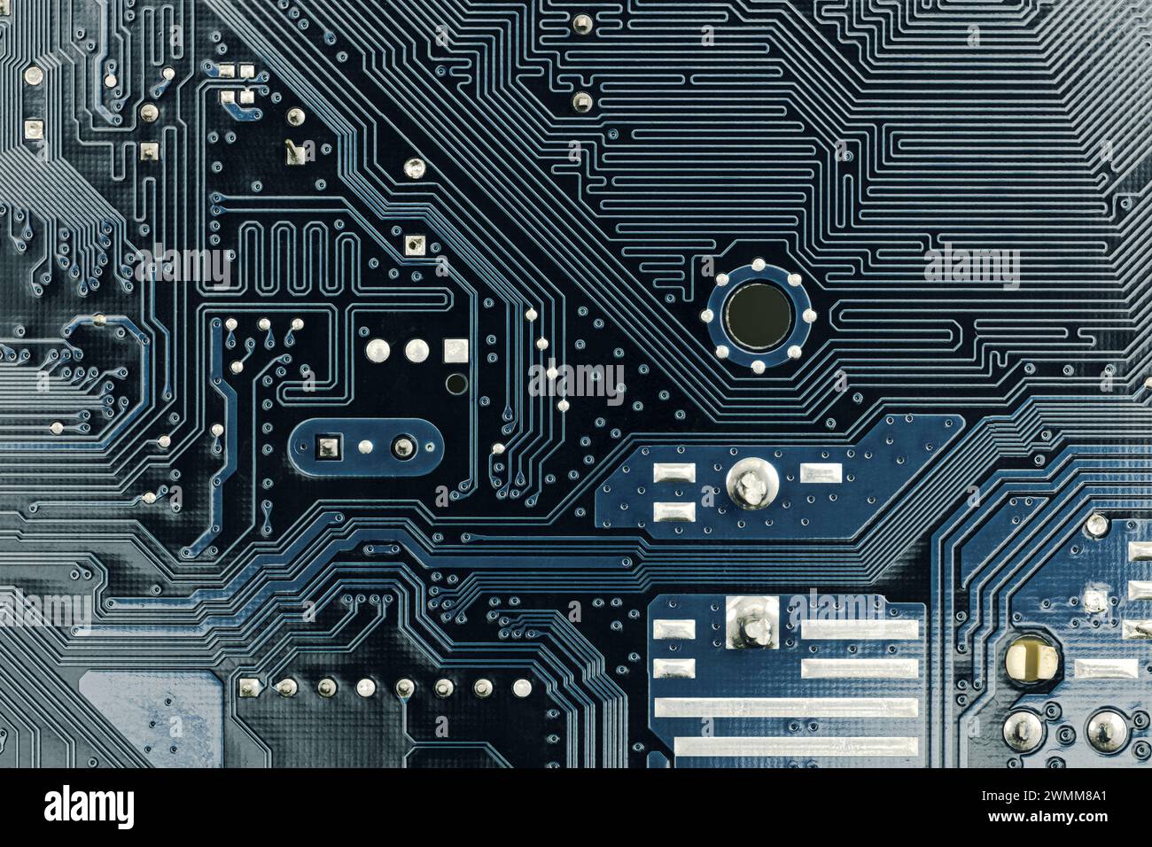 back side of computer mother board. circuit board connections. high ...