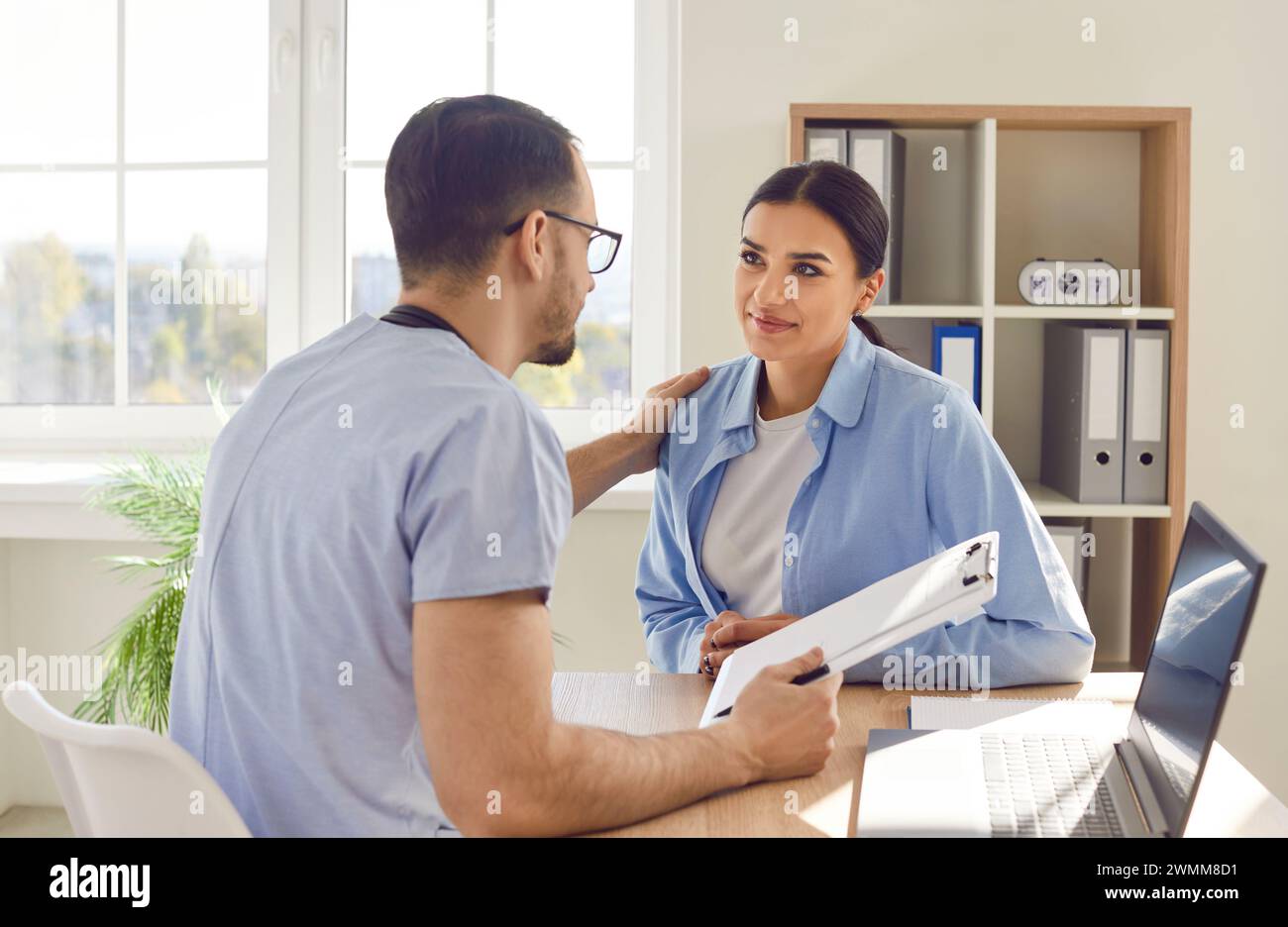 Doctor giving consultation to a woman during medical exam in clinic ...