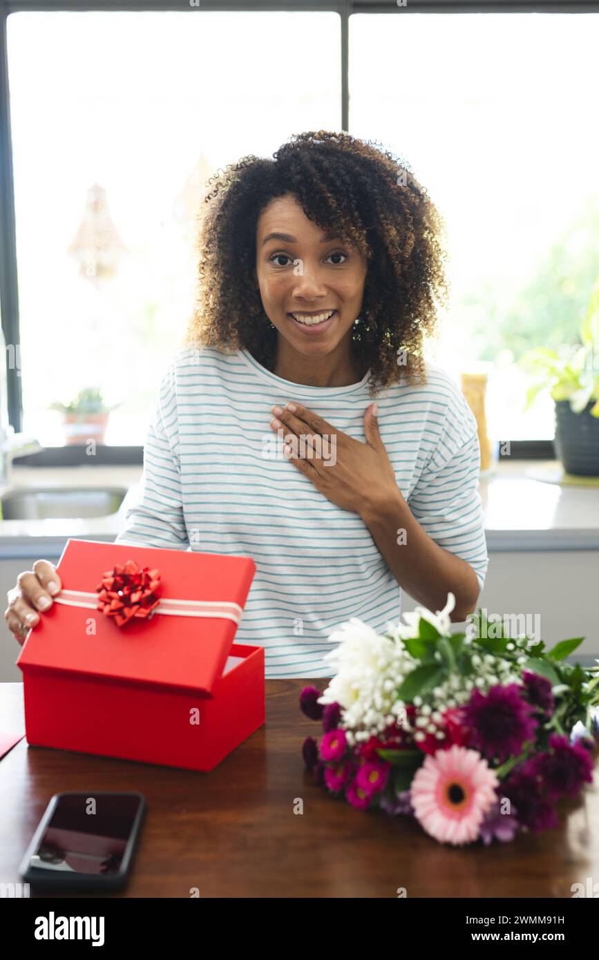 Biracial woman receives a surprise gift at home during an online date ...