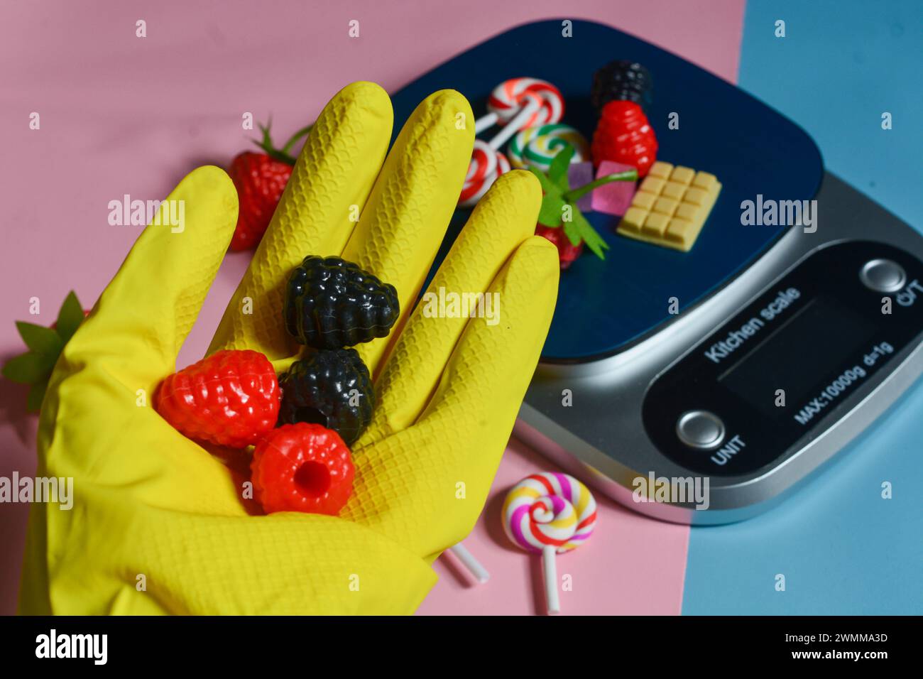 Digital scales that are weighing chocolate, strawberries and several ...