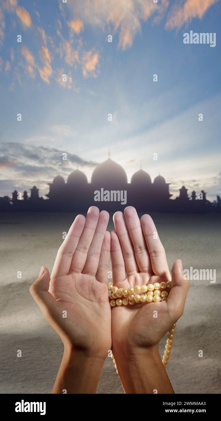 Muslim man's hand holding prayer beads is praying to Allah with a ...