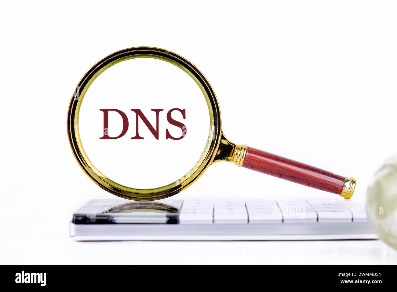 DNS. Domain Name System word writing through a magnifying glass on a ...