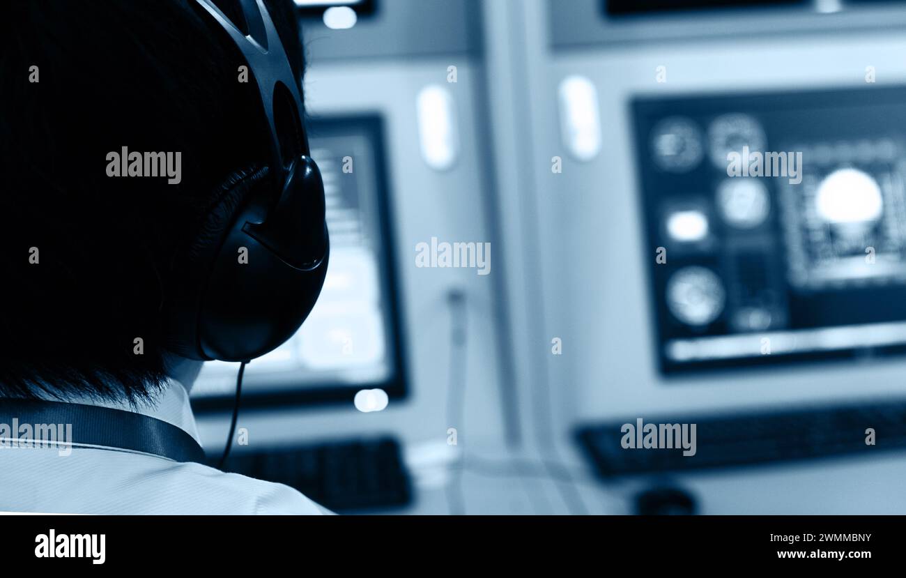 Rear view of flight controller working in the flight control tower ...