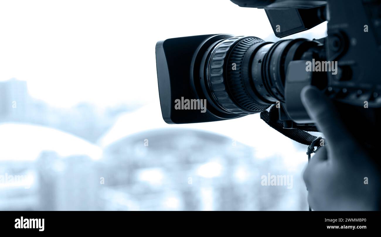 Closeup of television operator with camera Stock Photo - Alamy