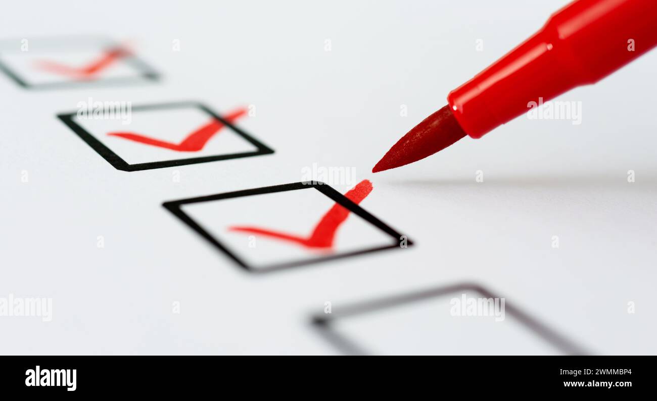 Checklist marked by red pen Stock Photo - Alamy