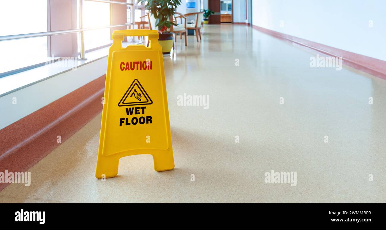 Freshly mopped hallway with a caution sign in English Stock Photo - Alamy