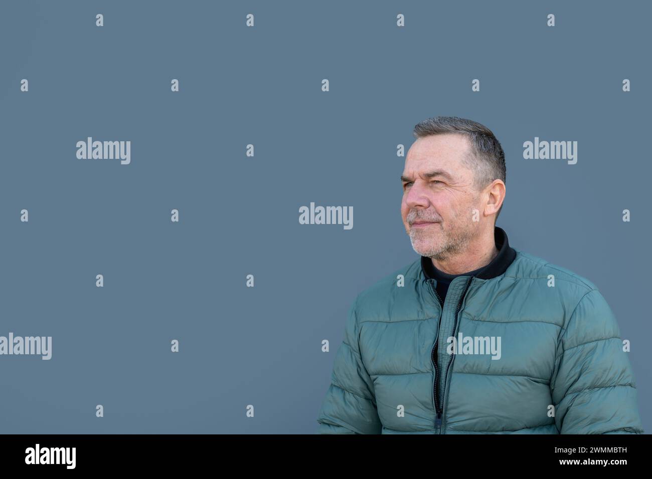 Upper body portrait of a middle aged man looking sideways into the ...